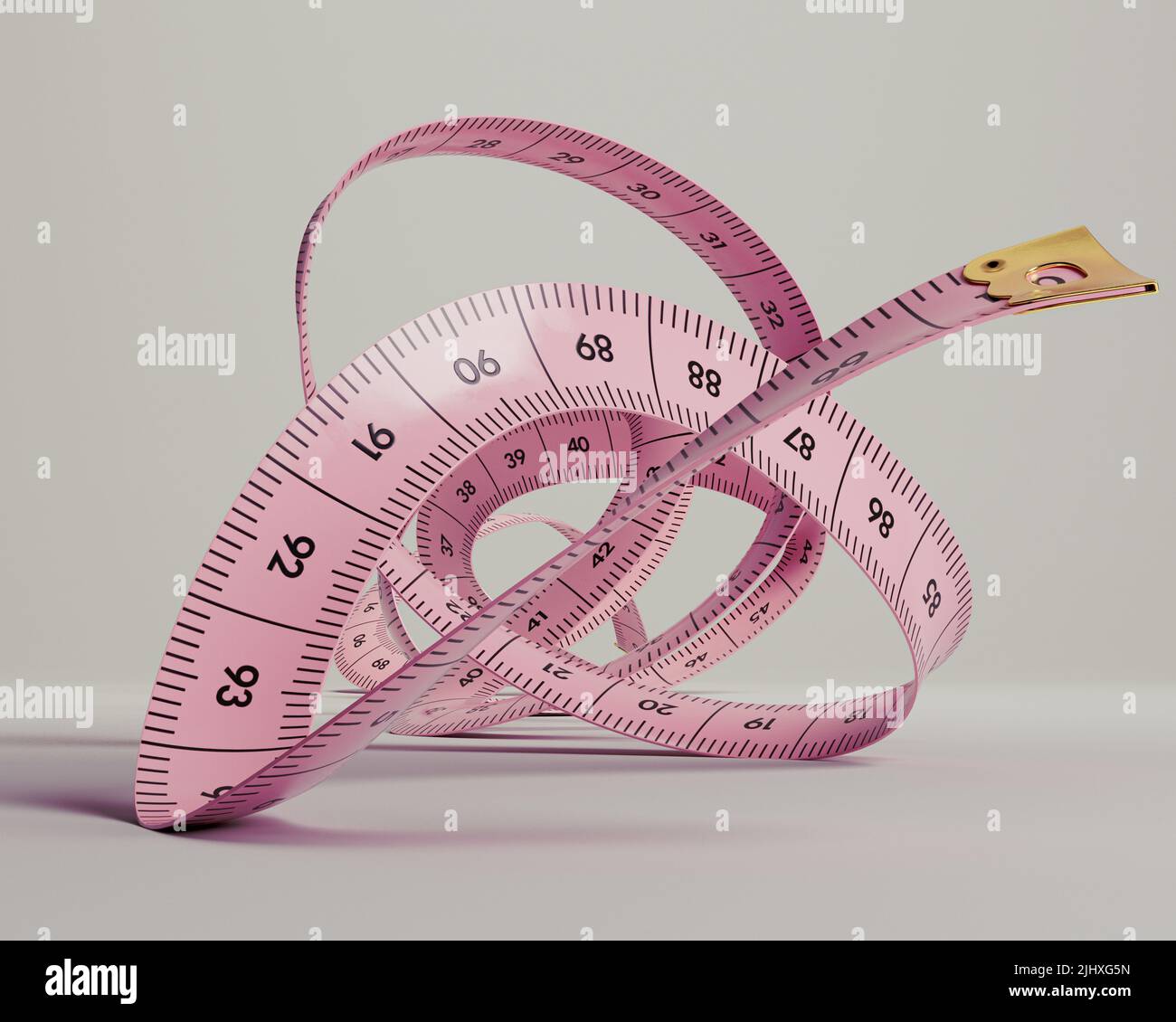 A pink curled and twisted up taylors measuring tape with measurements ...