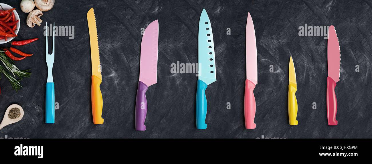 A shot of the multitype and colorful knives in the blackboard with ...