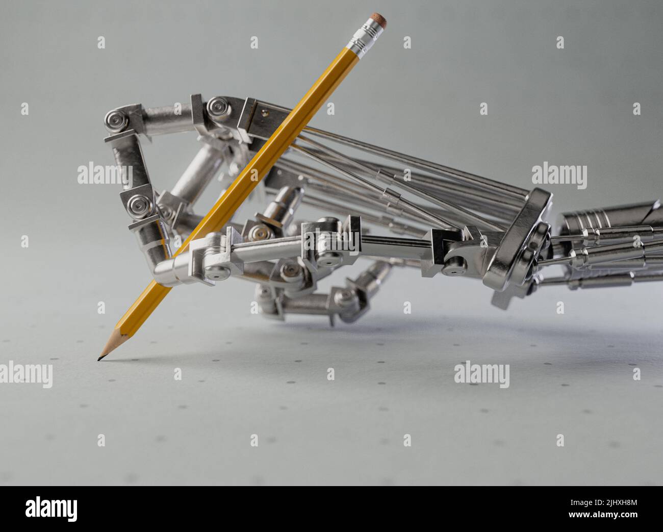 A mechanical robotic metal hand drawing or writing with a pencil on a ...