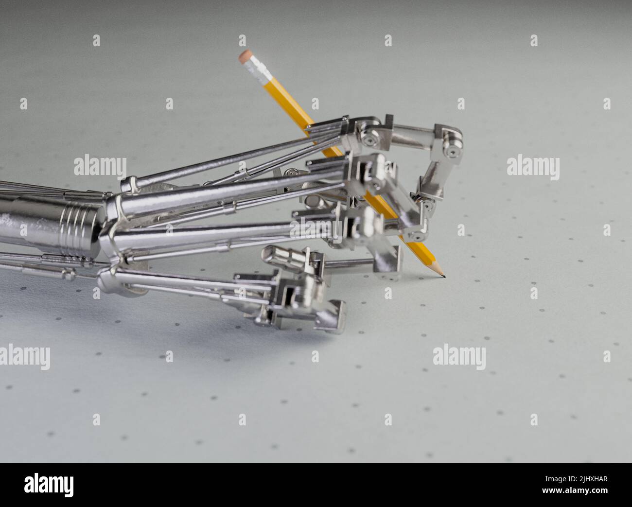 A mechanical robotic metal hand drawing or writing with a pencil on a ...
