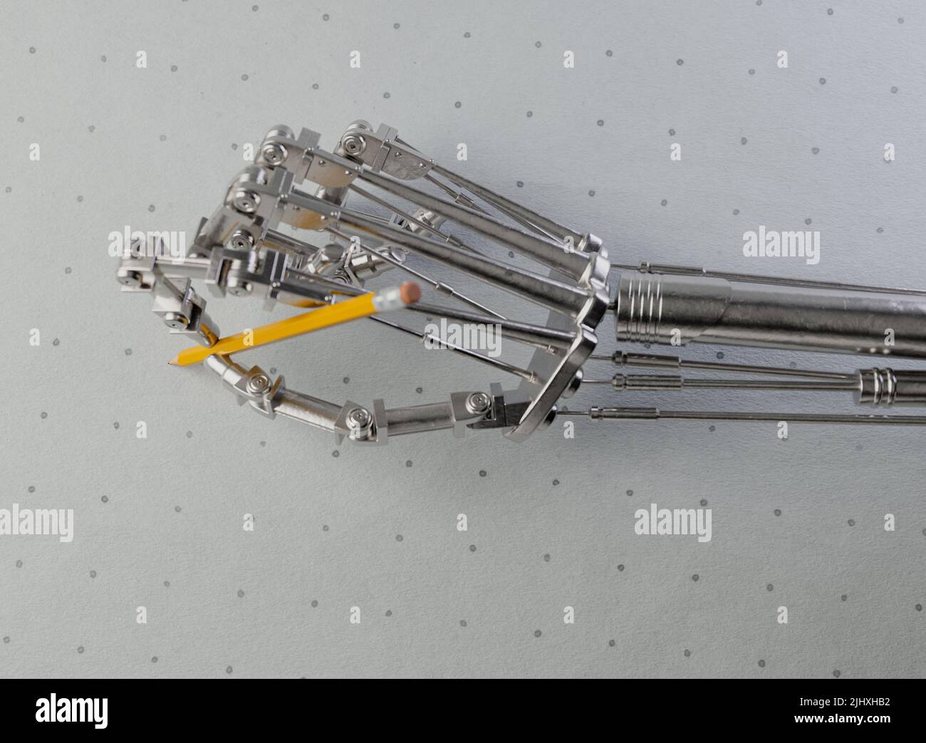 A mechanical robotic metal hand drawing or writing with a pencil on a ...
