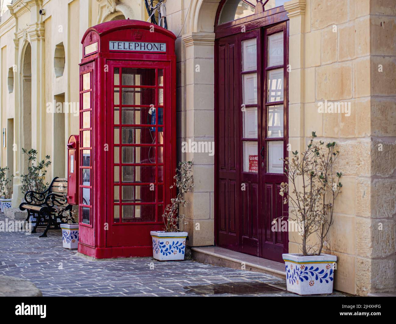 A red telephone box outside on the street Stock Photo - Alamy