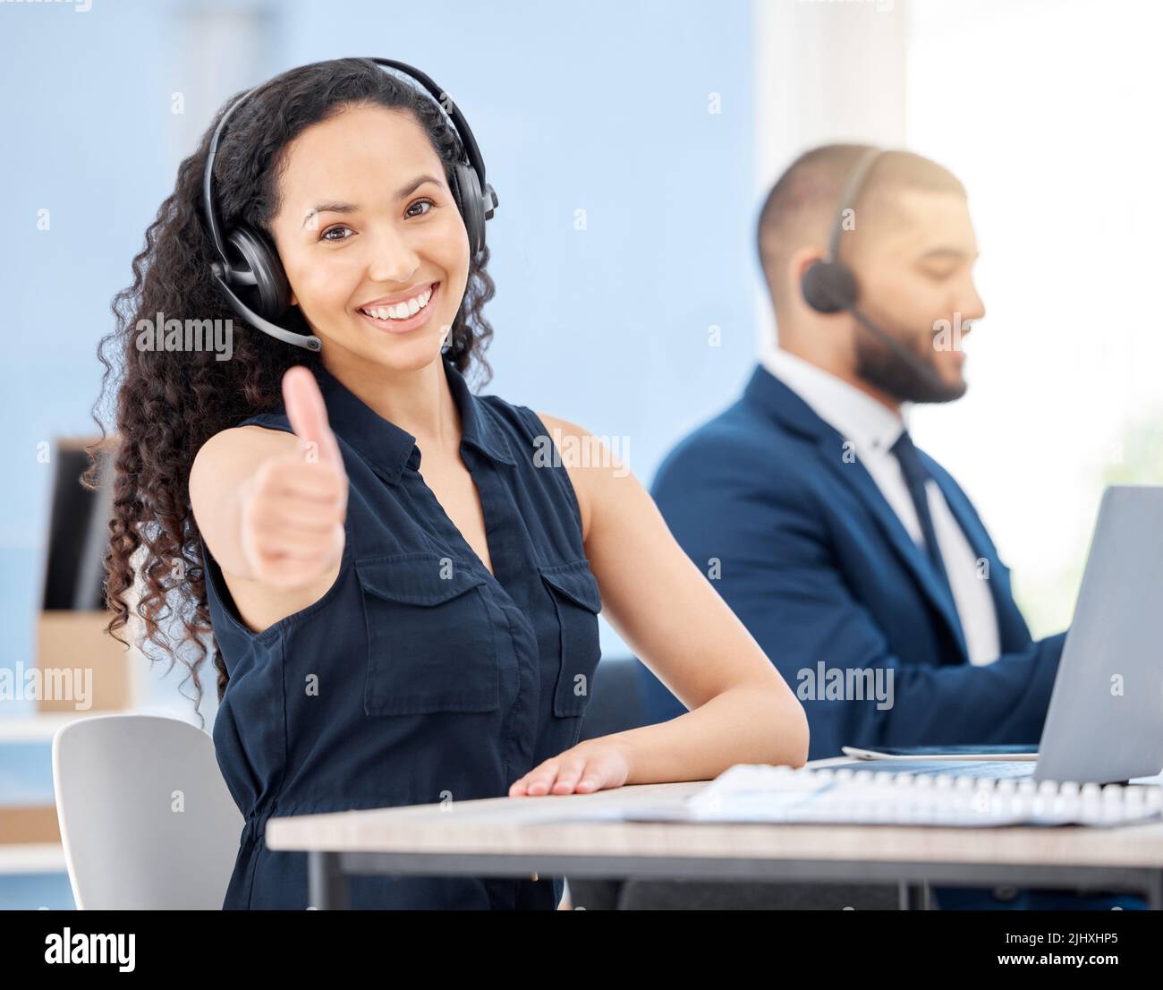 You can get a thumbs up. a young female call center agent showing a ...