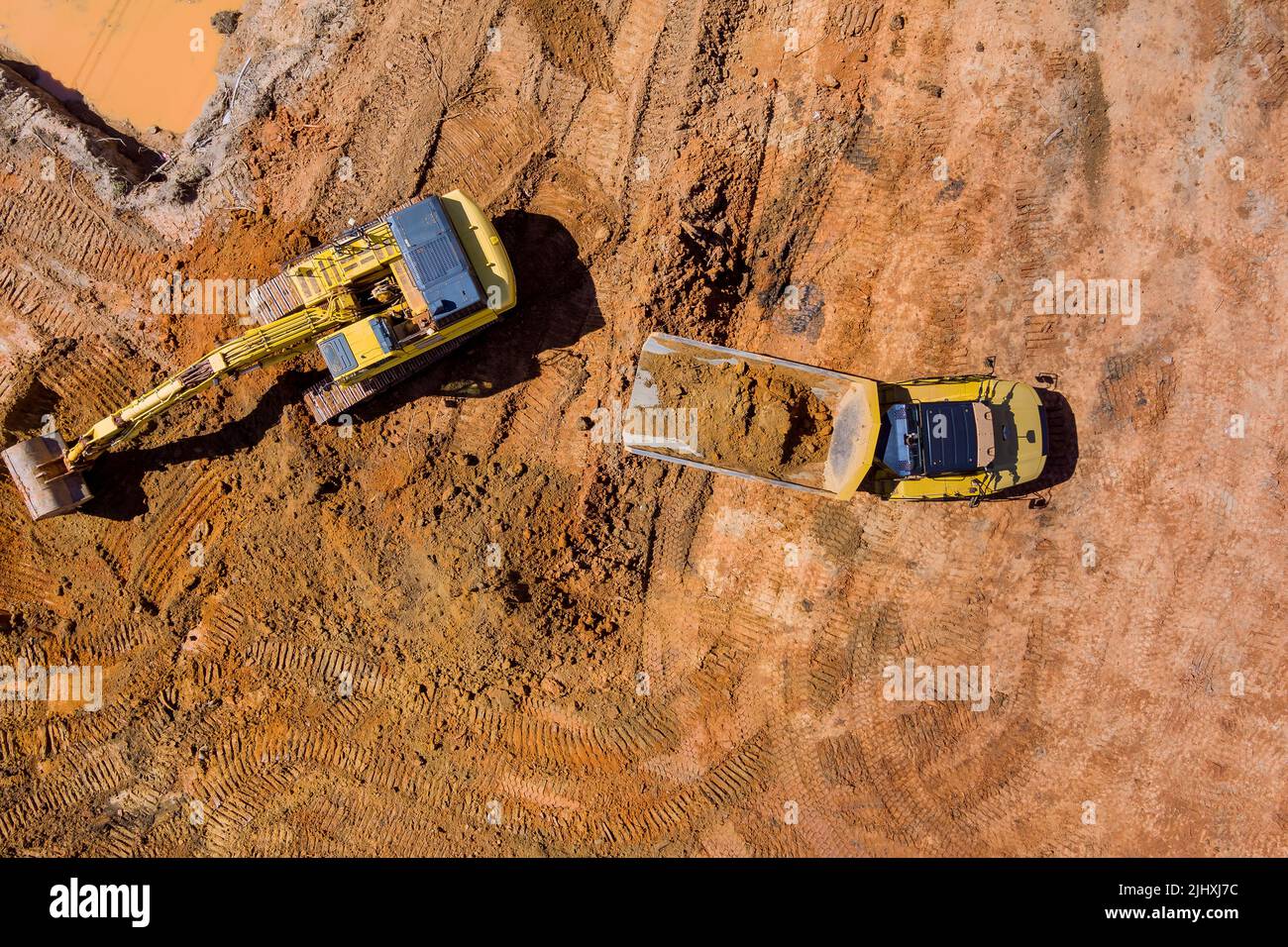 Preparation work with excavator dumping earth for loading into dump ...