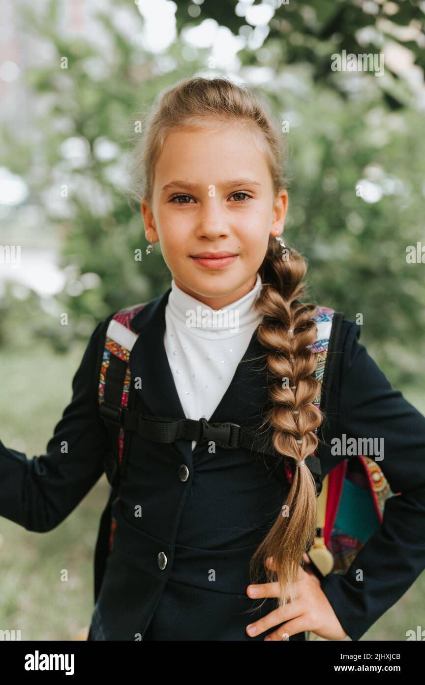back to school. little happy kid pupil schoolgirl eight years old in ...