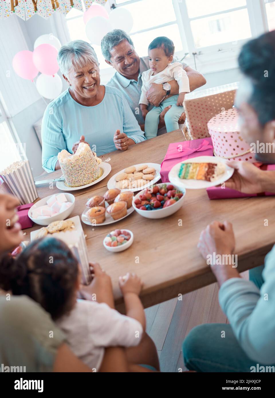 Deserved cheers. a family celebrating a birthday together at home Stock ...