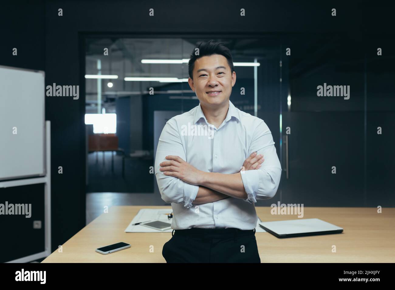 Portrait of successful asian boss in modern office, man standing with ...