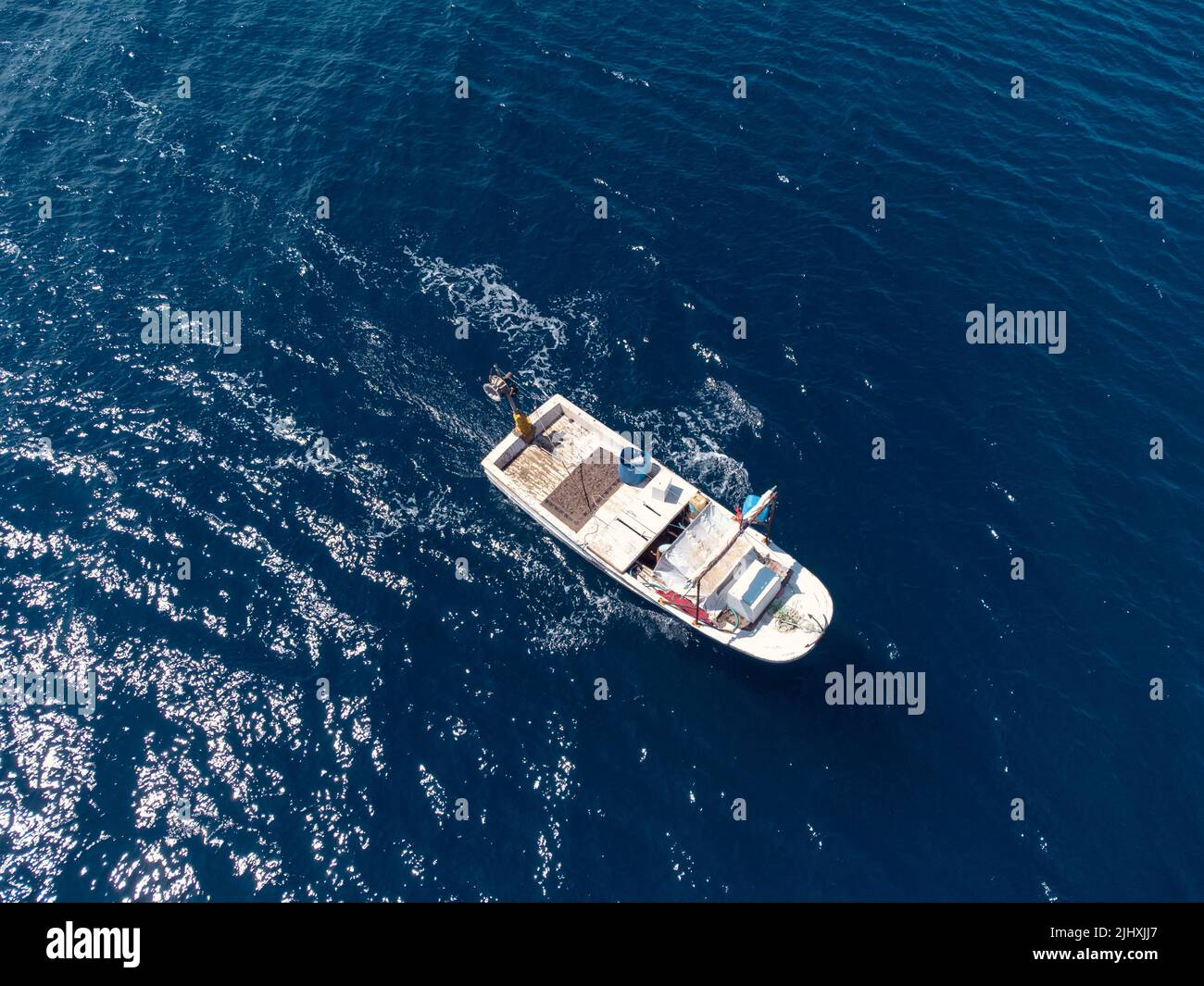 Aerial top view of sea with a white fishing boat Stock Photo - Alamy