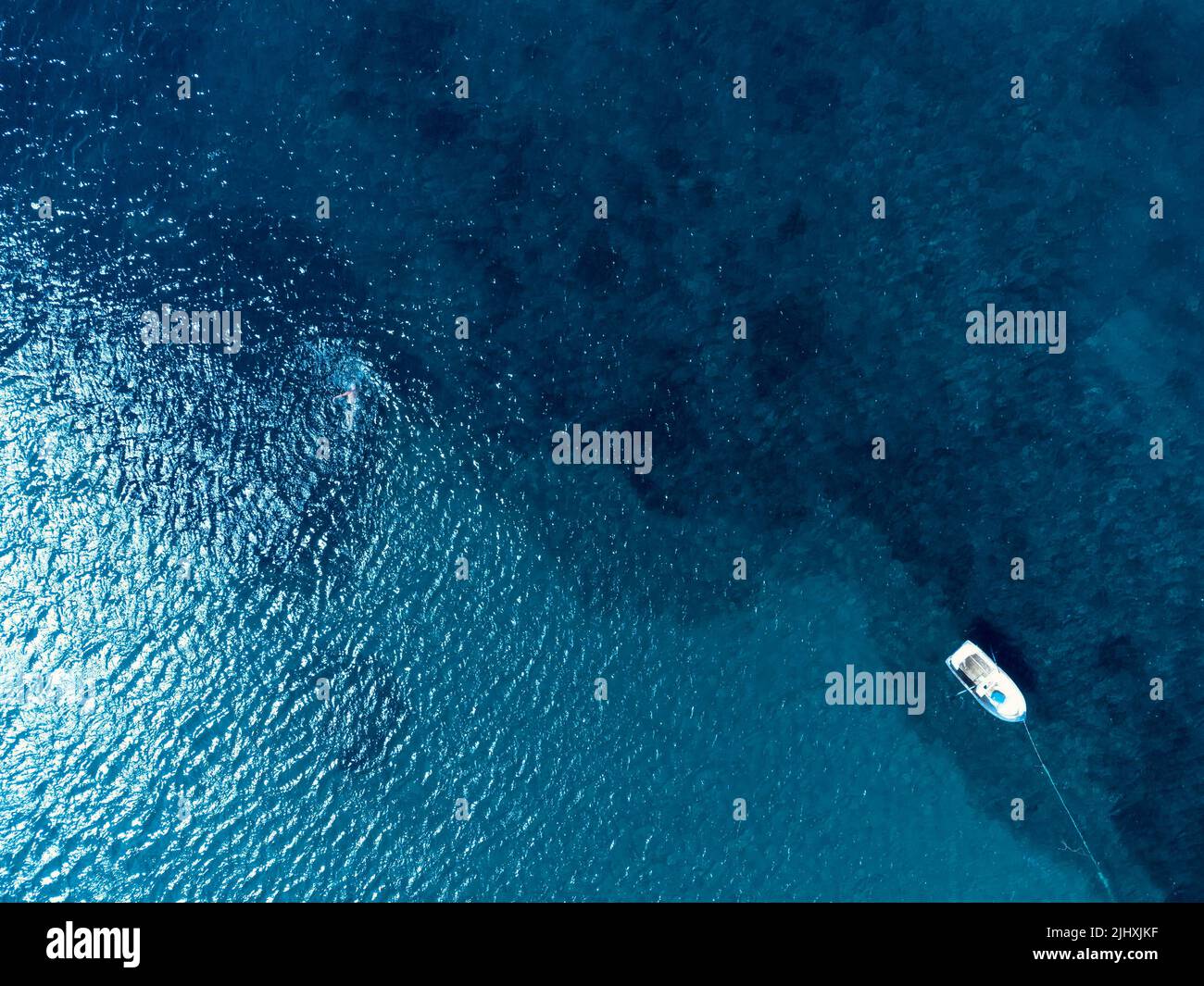 Aerial top view of sea with a white boat Stock Photo - Alamy