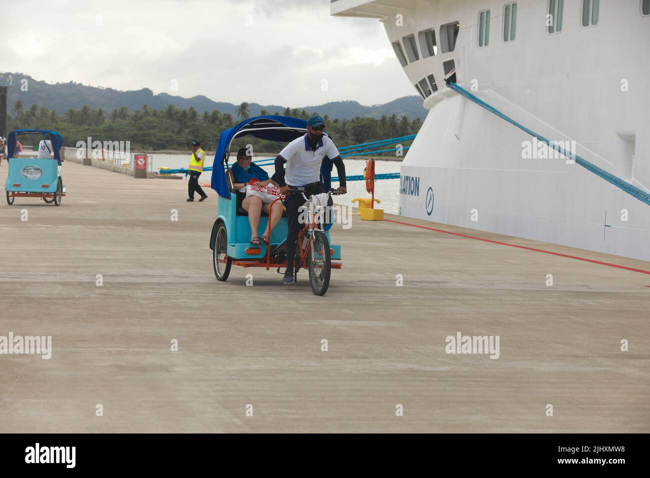 Bicycle rickshaw transferring guests from cruise ship terminal complex ...