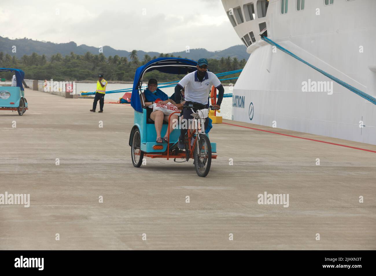 Bicycle rickshaw transferring guests from cruise ship terminal complex ...