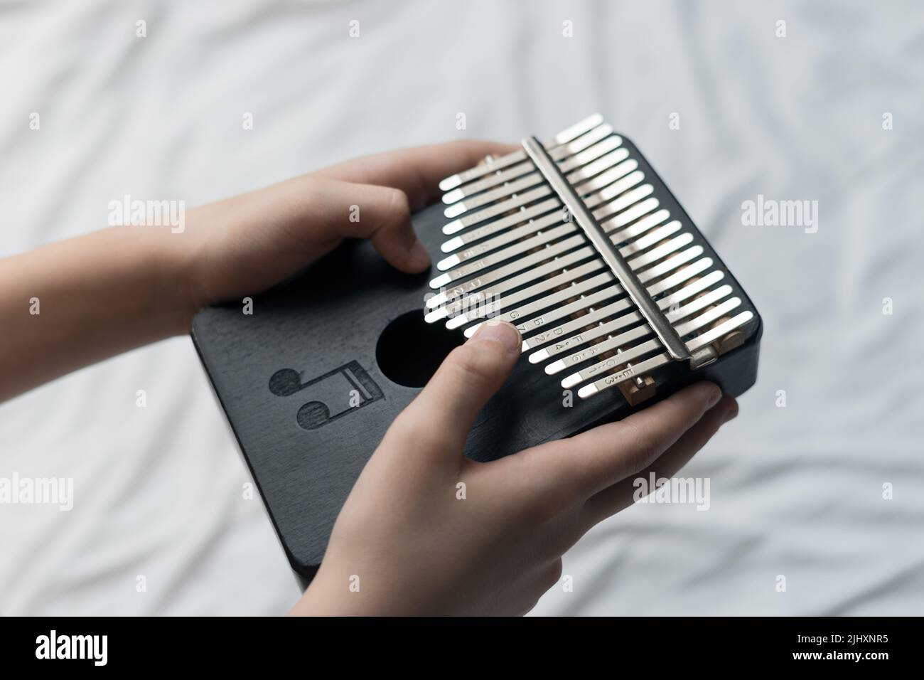 closeup of african musical instrument in hand or person playing on ...
