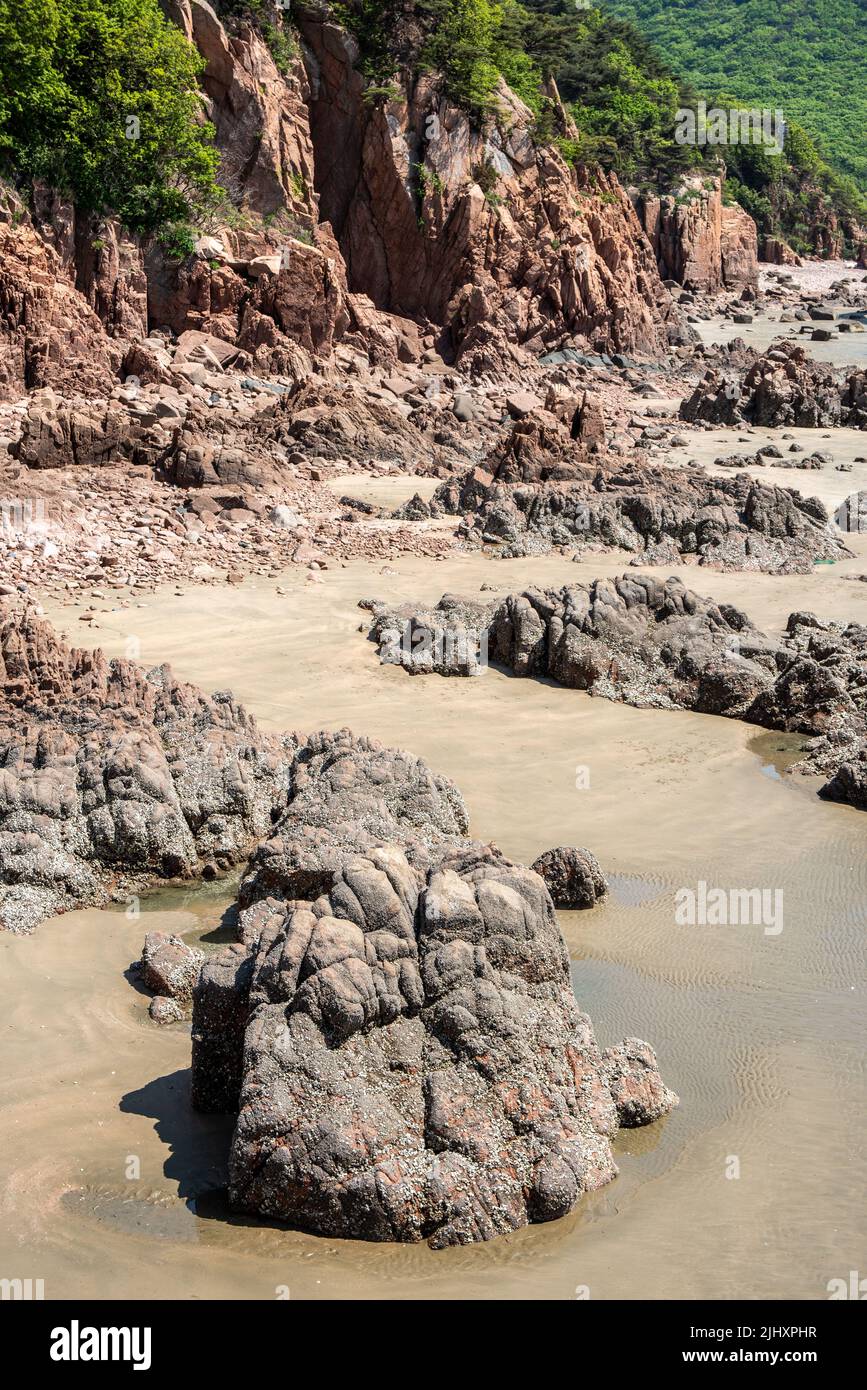 A vertical shot of big rock formations on the ocean coast Stock Photo ...