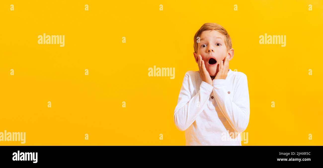 Portrait of surprised little boy, emotional kid isolated on bright ...