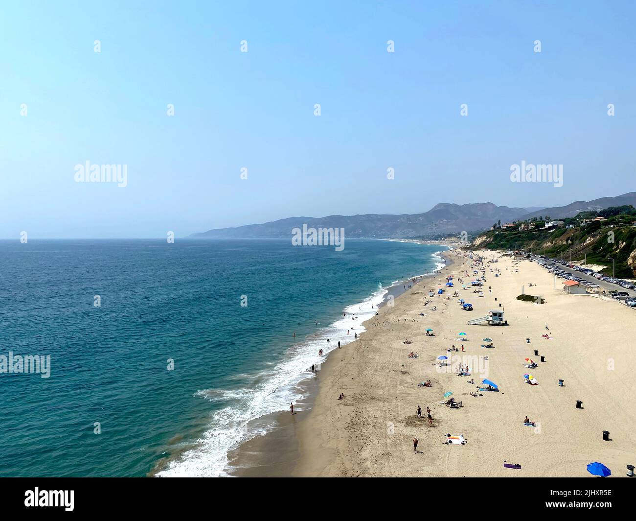 A beautiful view of the Malibu beach with people in California seen ...