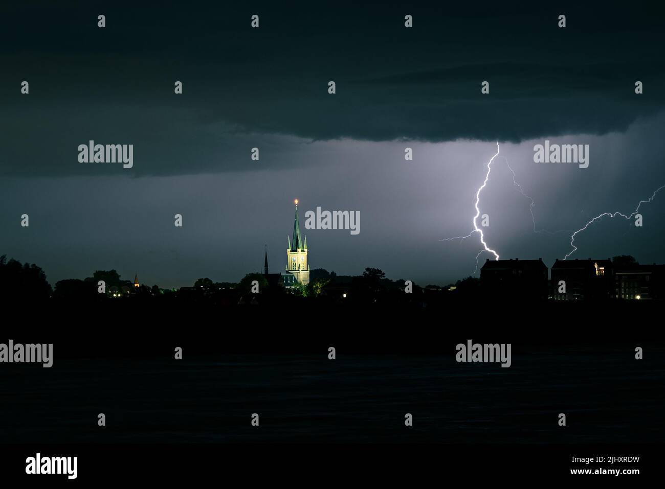 Lightning bolts strike next to an illuminated church Stock Photo - Alamy