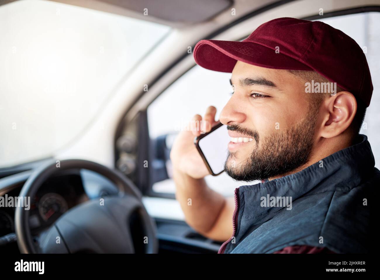 On route. a handsome young male courier out making deliveries Stock ...