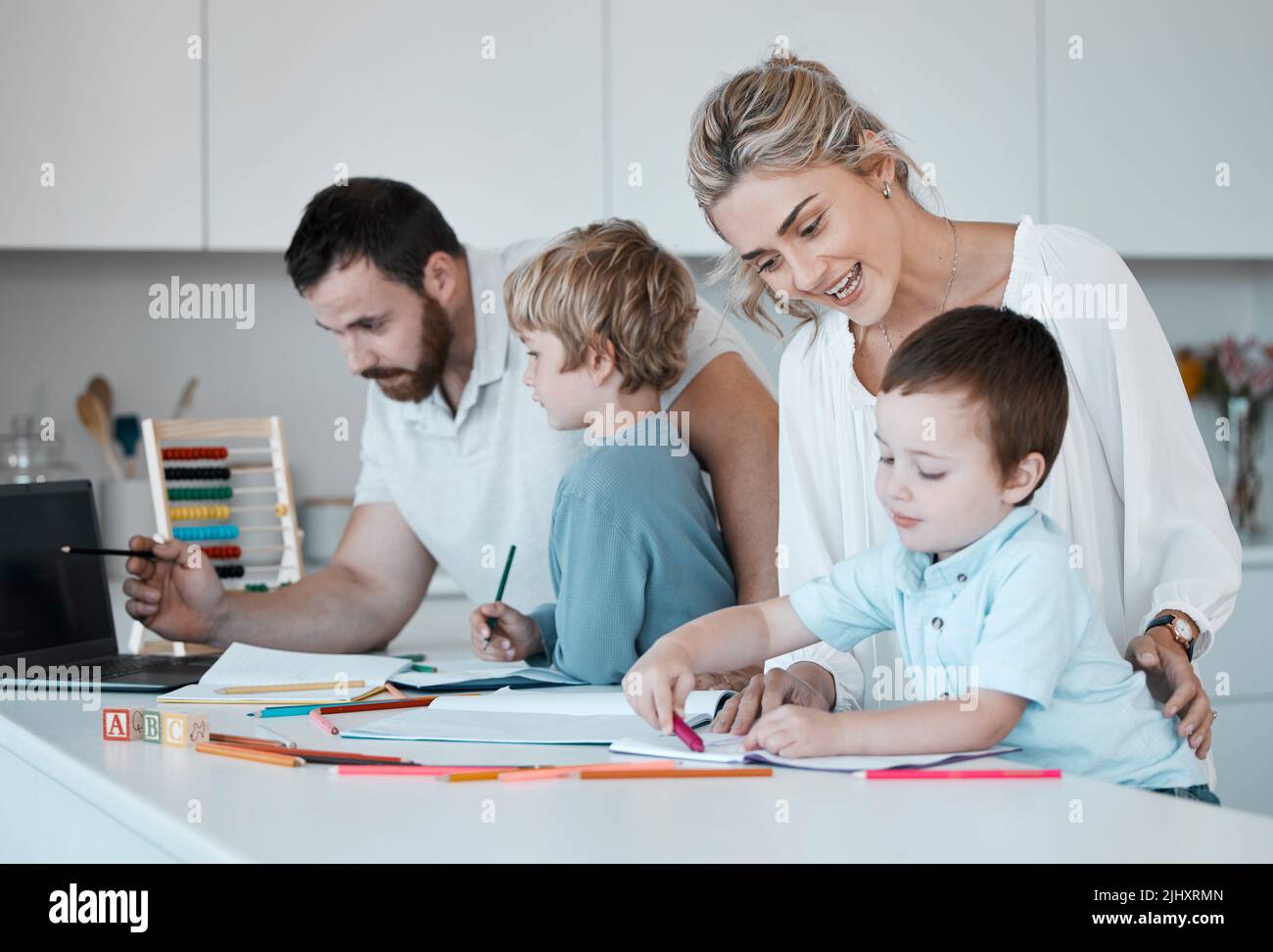 Young caucasian family homeschooling their two children. Loving parents ...