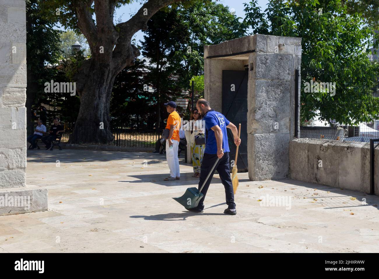 A worker picking up trash around Mihrimah sultan mosque uskudar ...