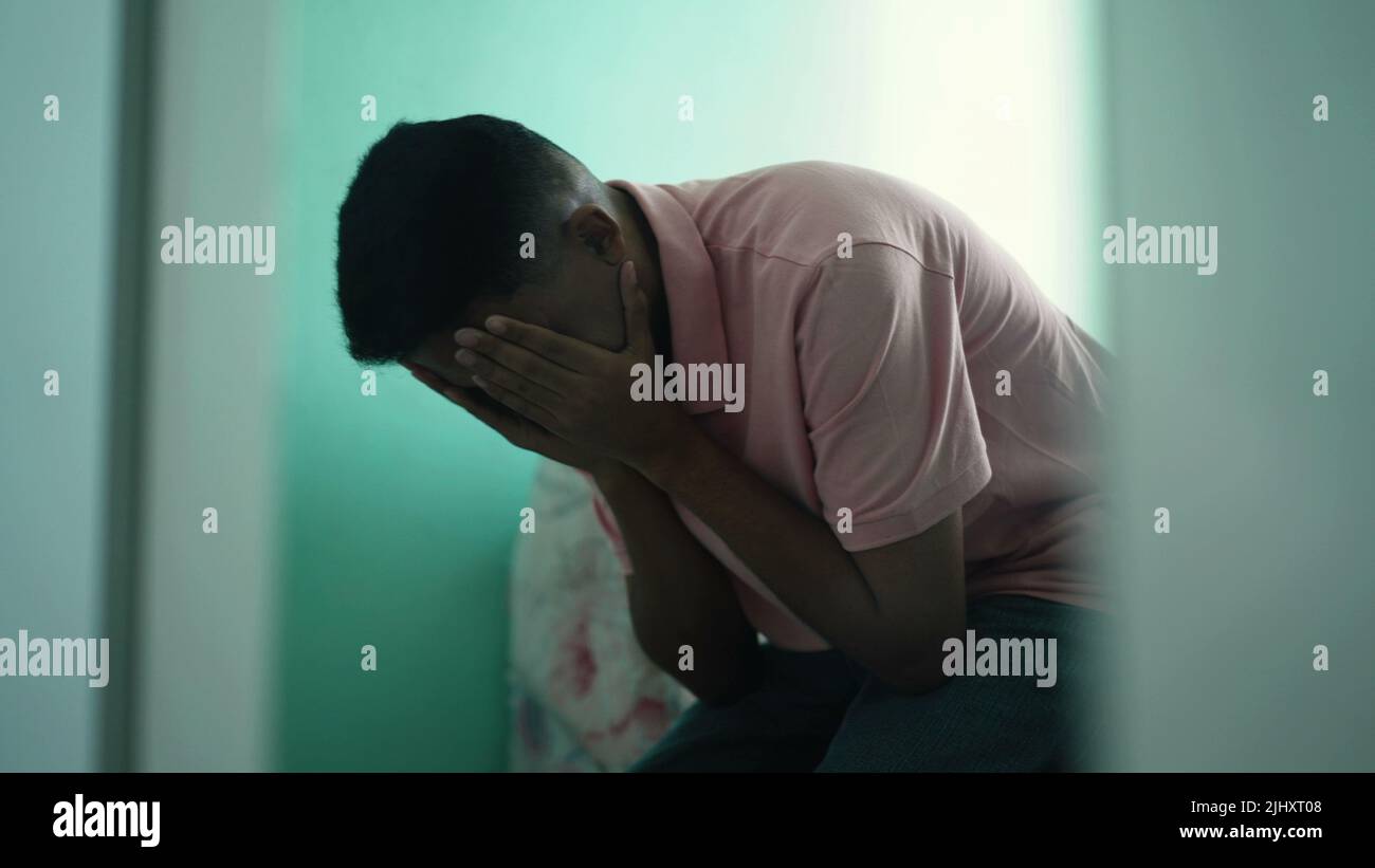 Anxious young man covering face suffering from mental illness. Mirror ...