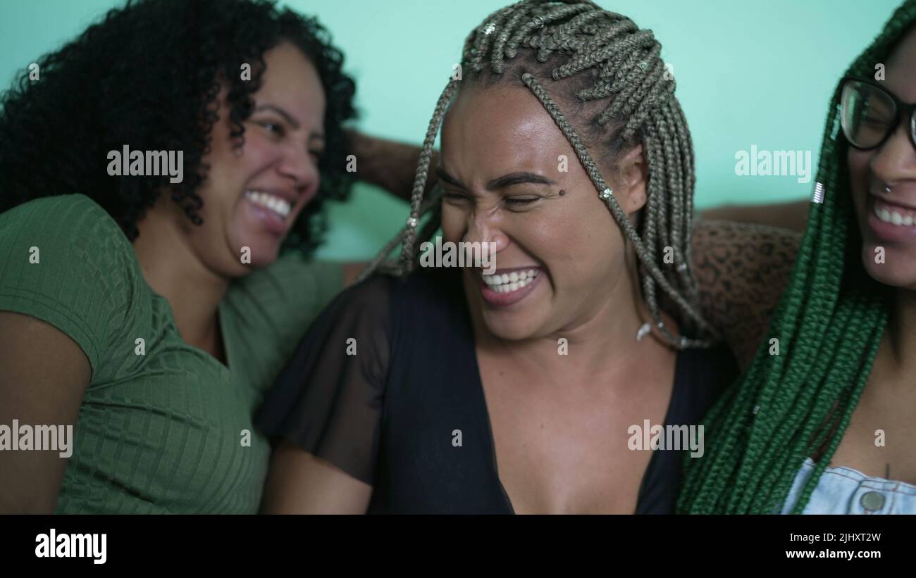 Happy female friends embrace. Three happy black African women laughing ...