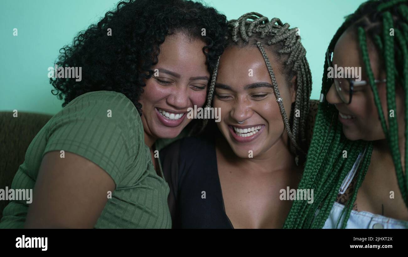 Happy female friends embrace. Three happy black African women laughing ...