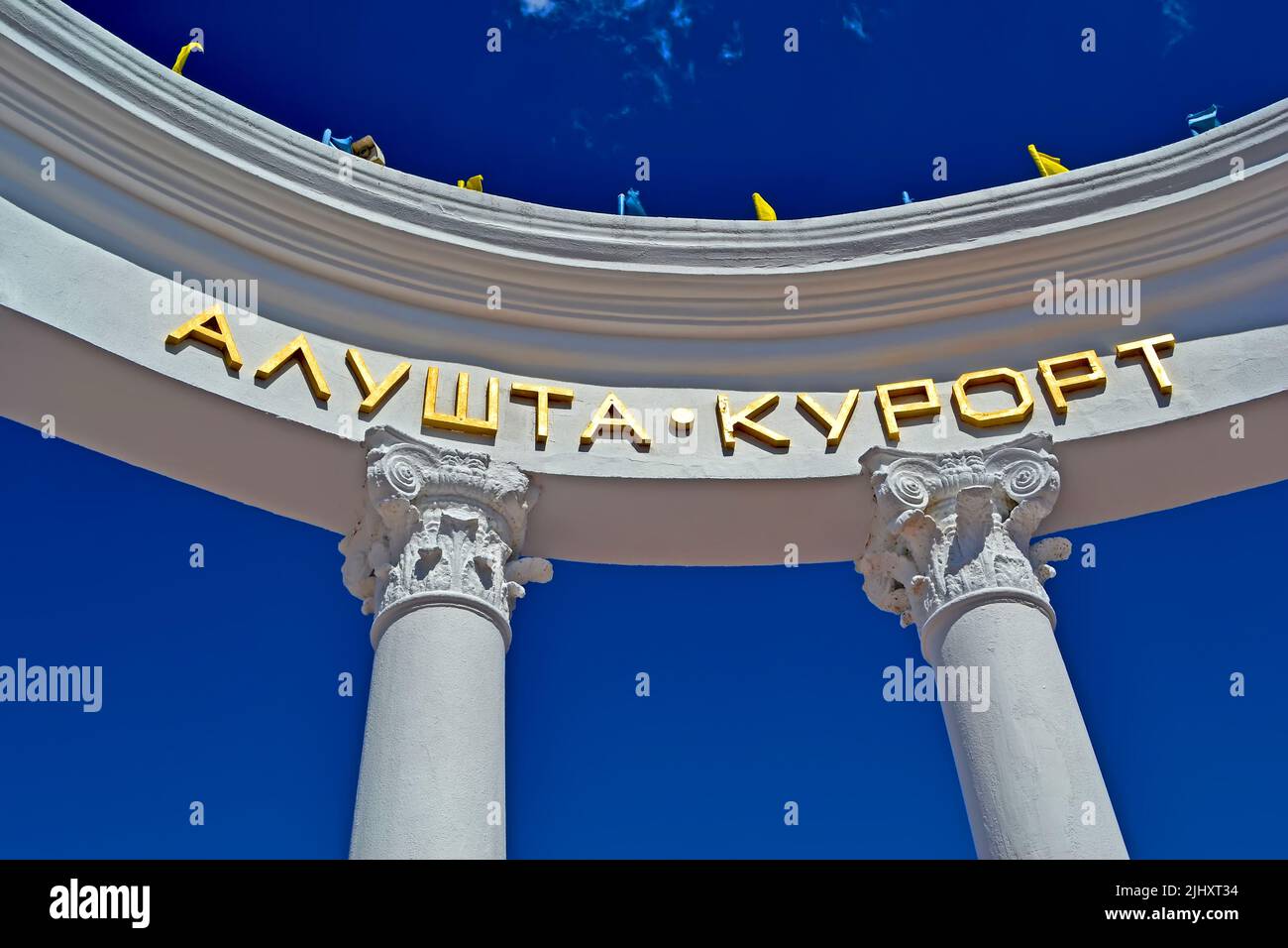 Alushta - resort as welcome message on white colonnade with blue sky ...