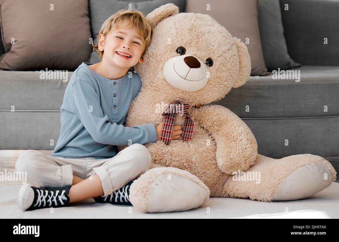 Portrait of one happy little caucasian boy smiling while hugging a big ...
