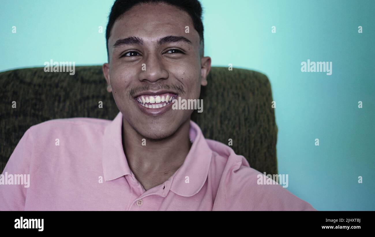 A happy hispanic man laughing and smiling. Candid south american person ...