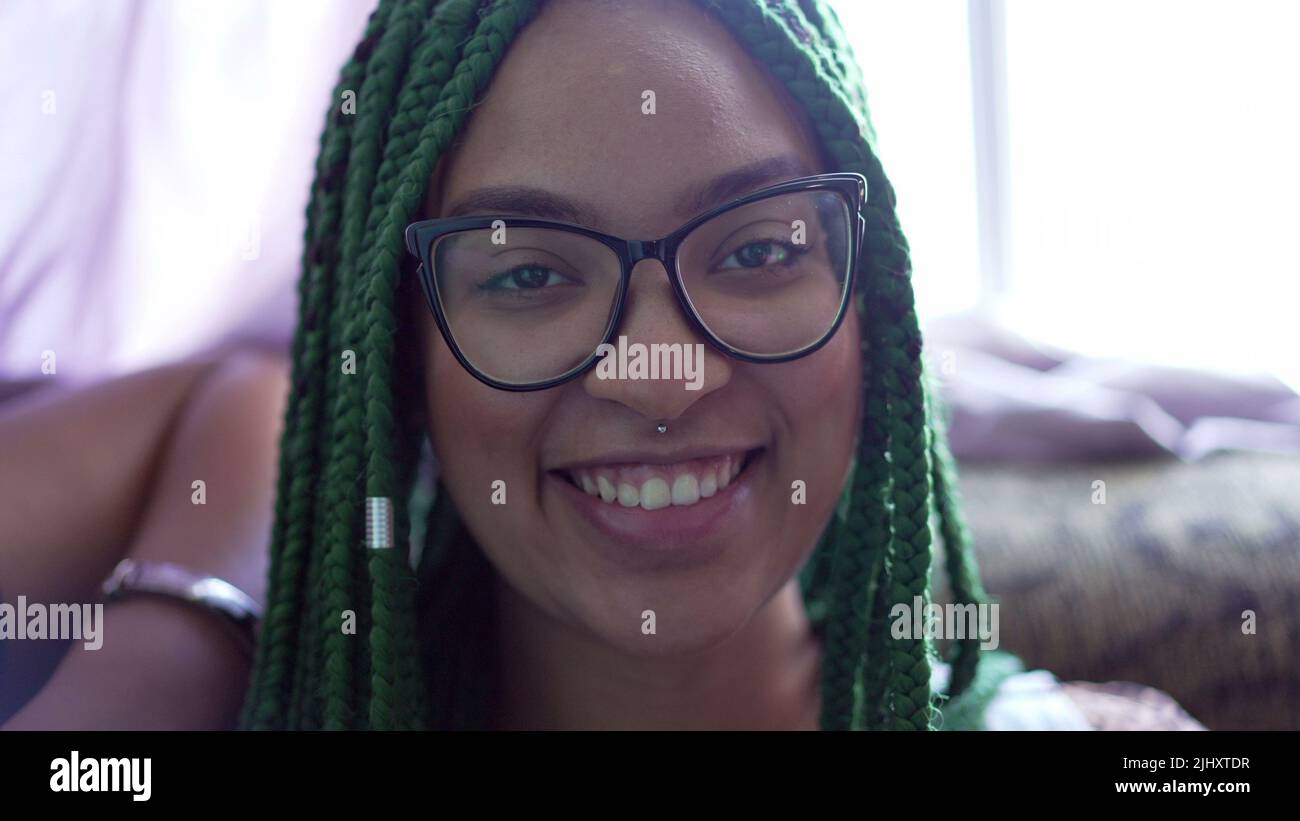A young black hispanic woman portrait face. Latina girl turning head to ...