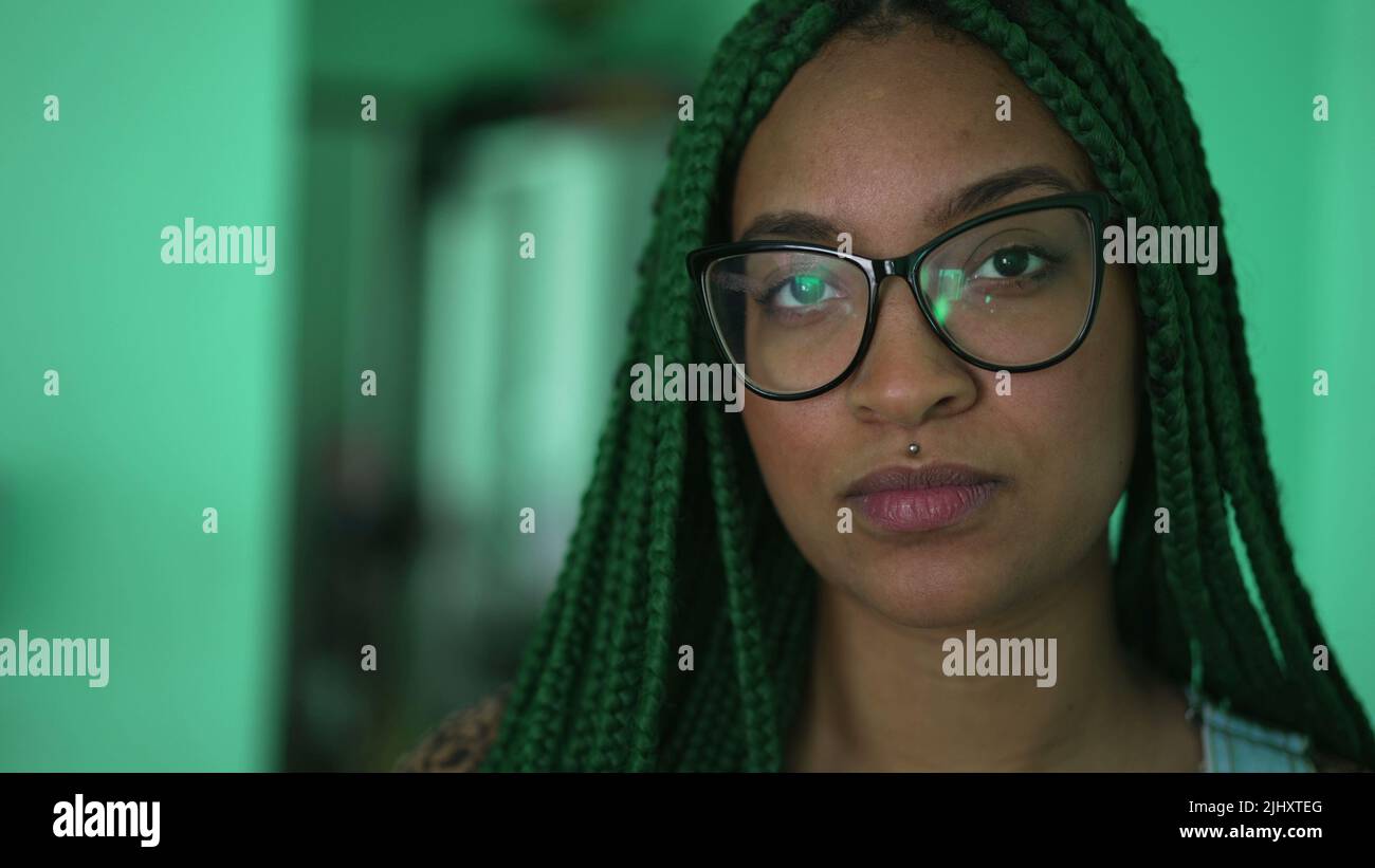 One young serious black woman with box braids hairstyle portrait face ...
