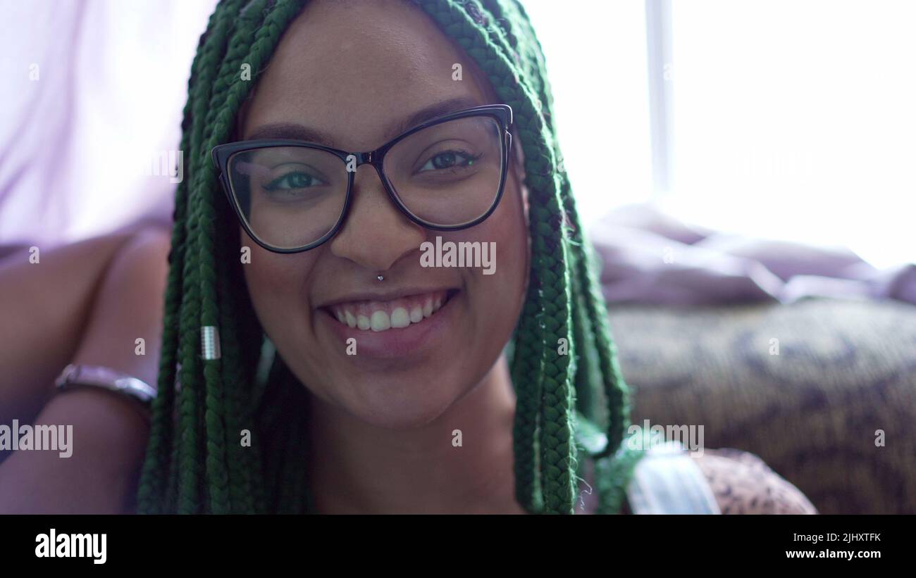 A young black hispanic woman portrait face. Latina girl turning head to ...