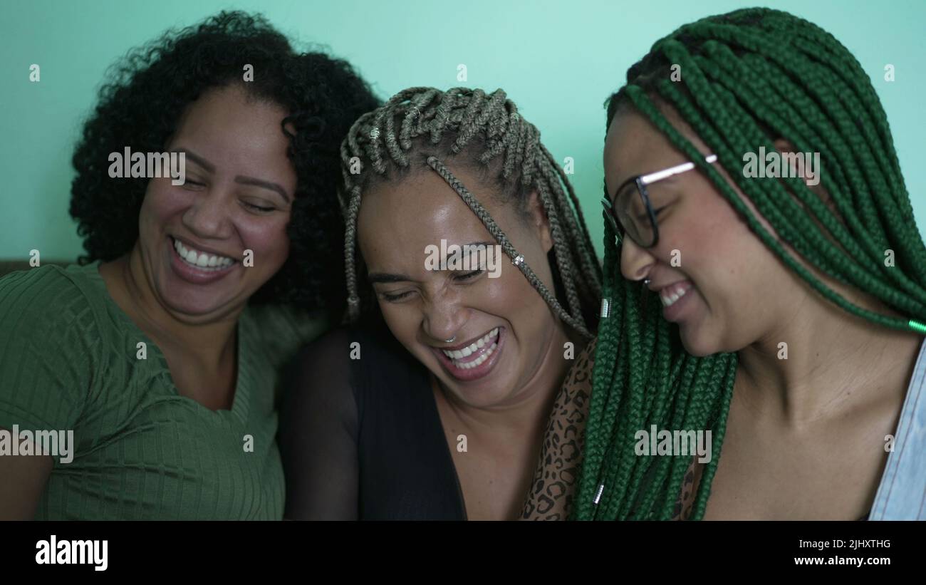 Three happy black African American women laughing and laughing ...