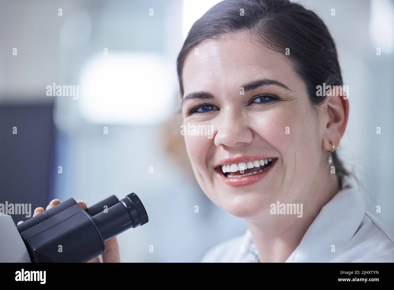 Making the most of her equipment. a young female lab tech using her ...