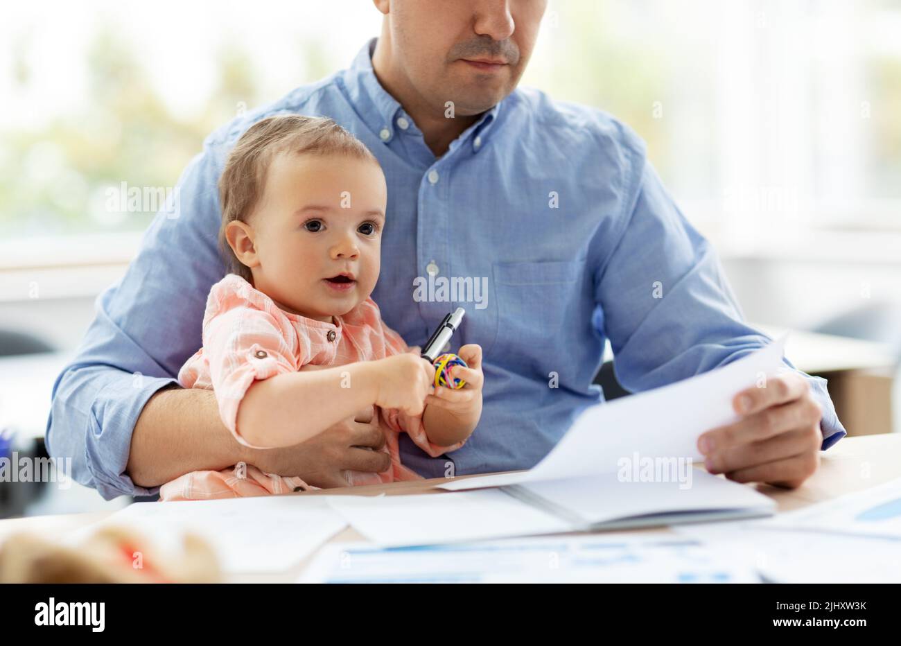 father with baby working at home office Stock Photo - Alamy