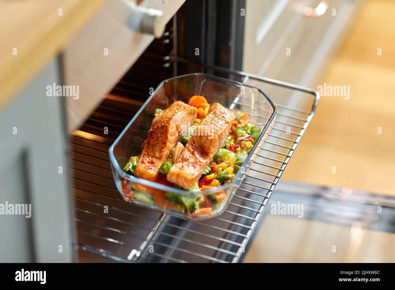 food cooking in baking dish in oven at home Stock Photo - Alamy