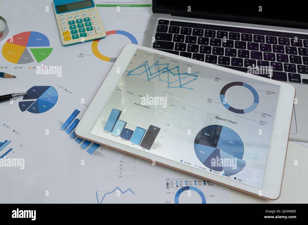 Document paperwork graph and chart at tablet with computer laptop and ...