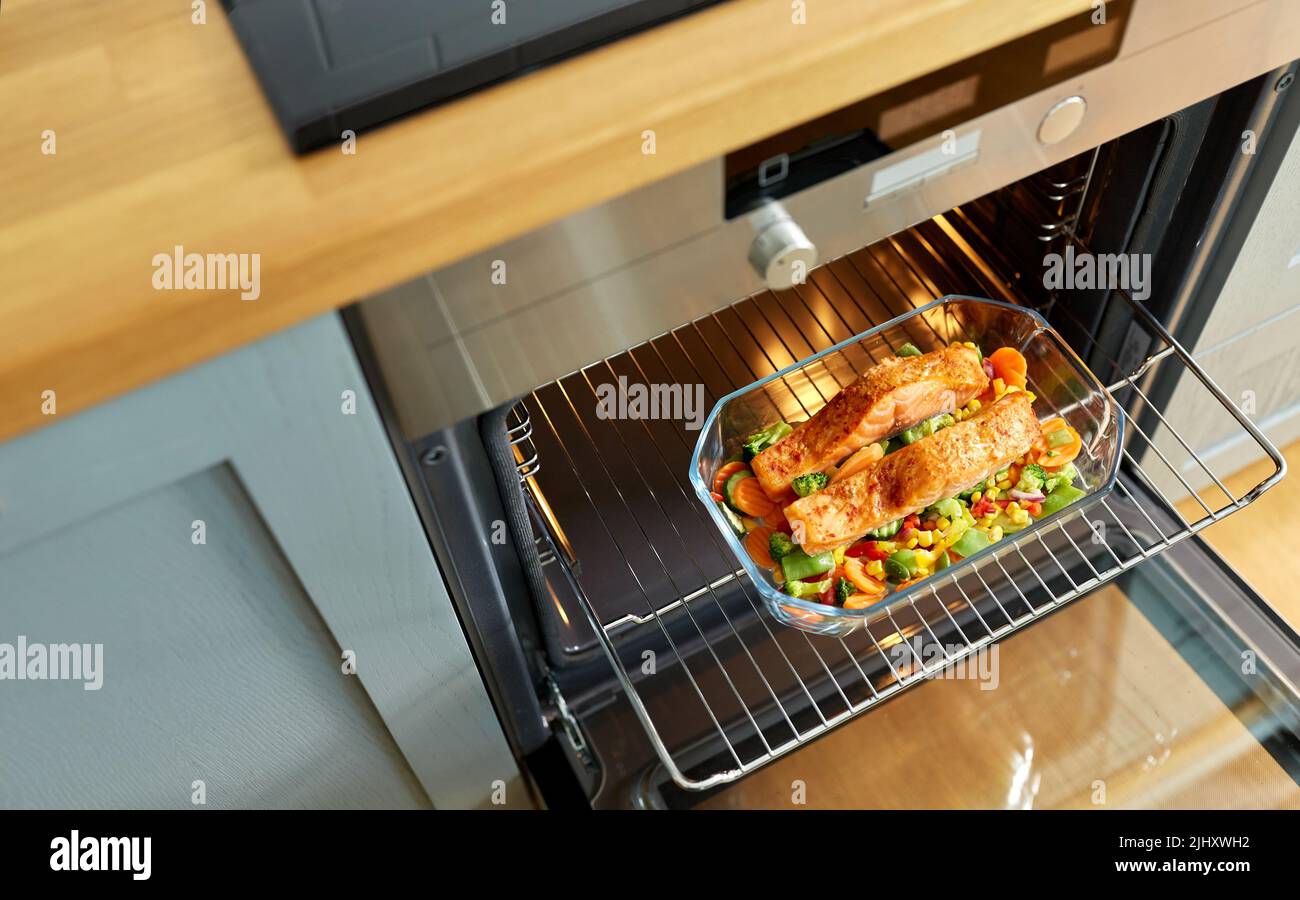 food cooking in baking dish in oven at home Stock Photo - Alamy