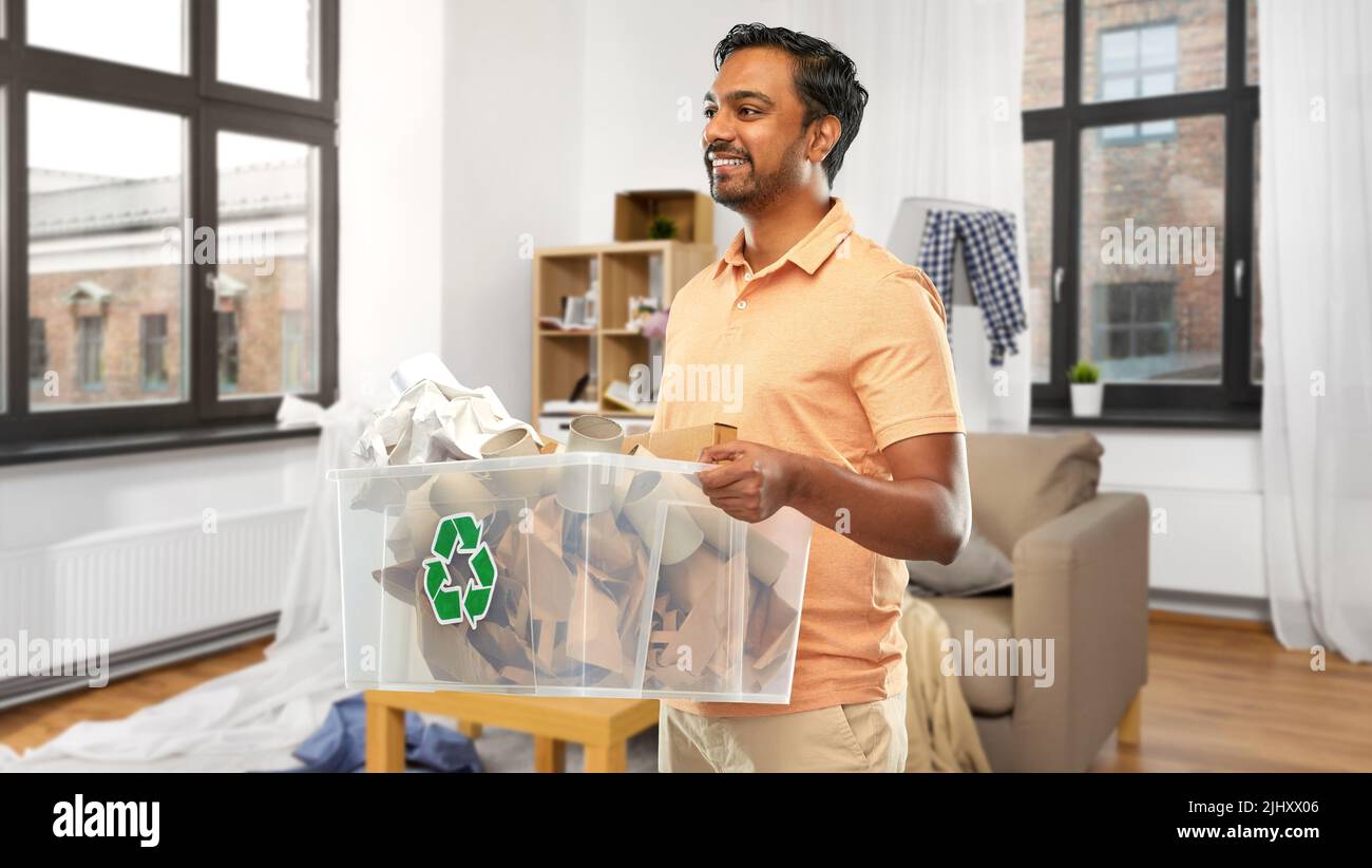 smiling young indian man sorting paper waste Stock Photo - Alamy
