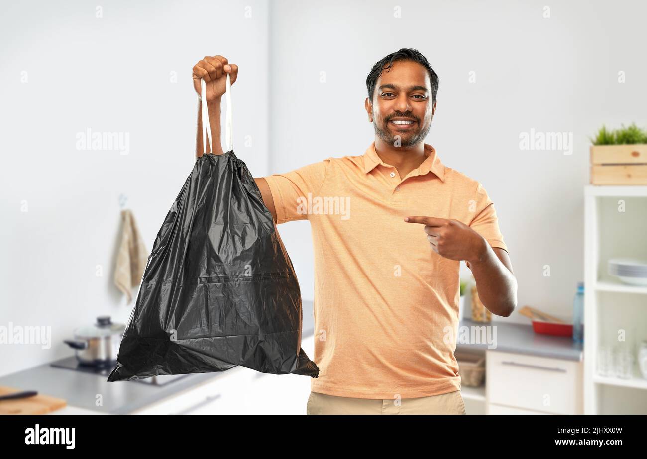 smiling indian man holding trash bag Stock Photo - Alamy