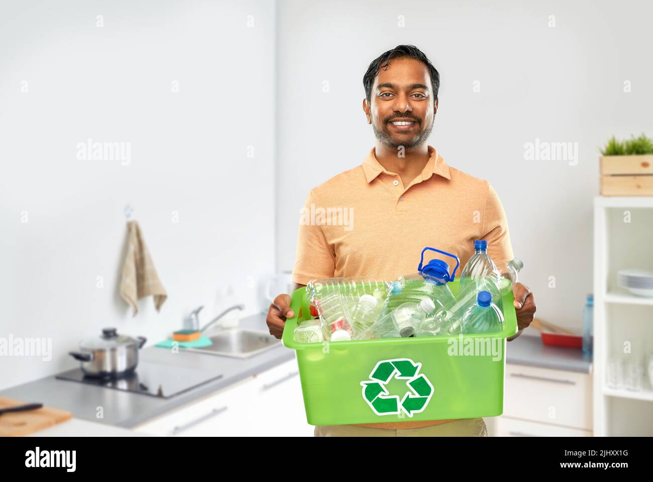 smiling young indian man sorting plastic waste Stock Photo - Alamy