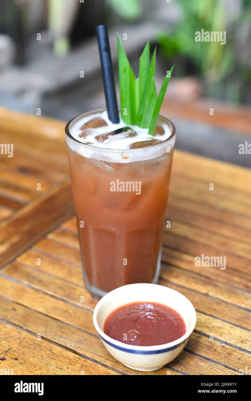 Iced plum tea with jam on wooden planks background Stock Photo - Alamy