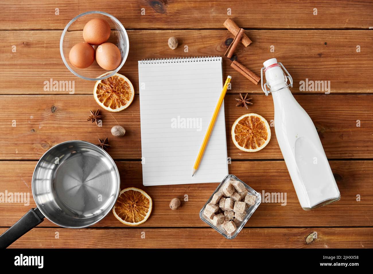 notebook, pencil, ingredients for eggnog cooking Stock Photo - Alamy