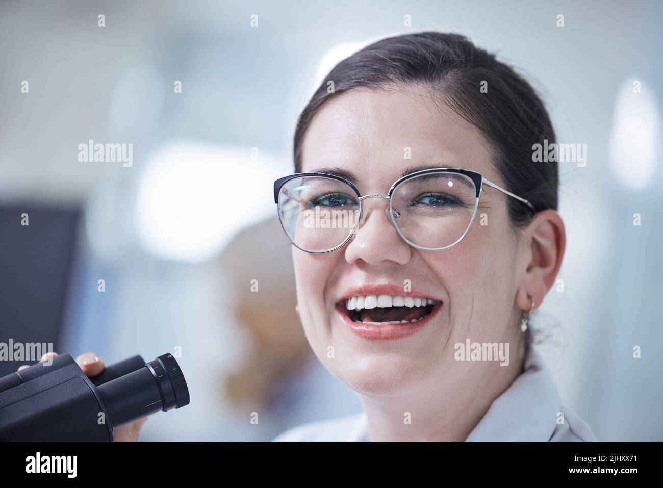The search of a lifetime. a young female lab tech using her microscope ...