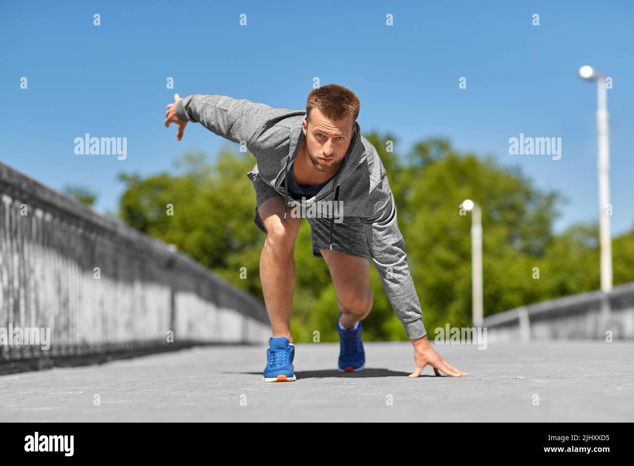 young man running across city bridge Stock Photo - Alamy
