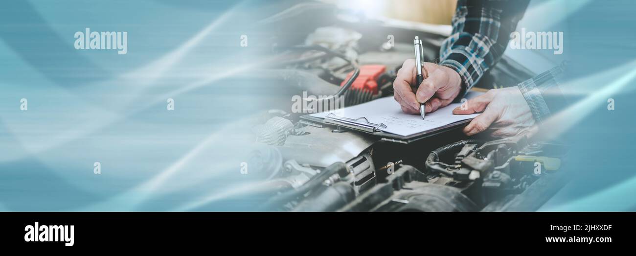 Car mechanic checking a car engine and writing on clipboard; panoramic ...