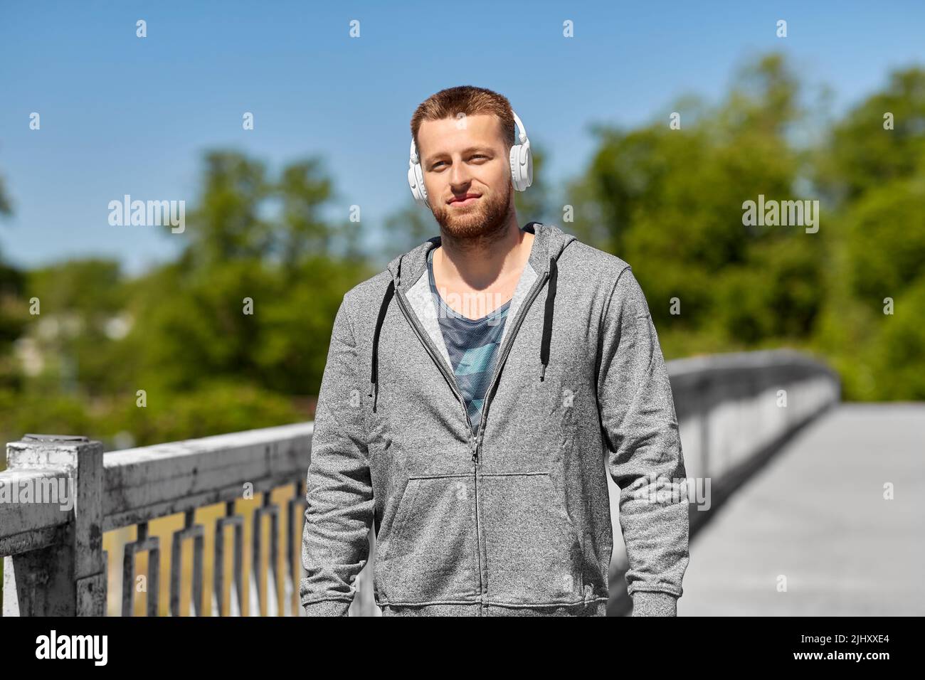 man in headphones listening to music outdoors Stock Photo - Alamy