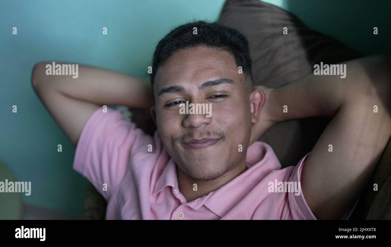 One happy hispanic man lying on couch relaxing. Confident person ...