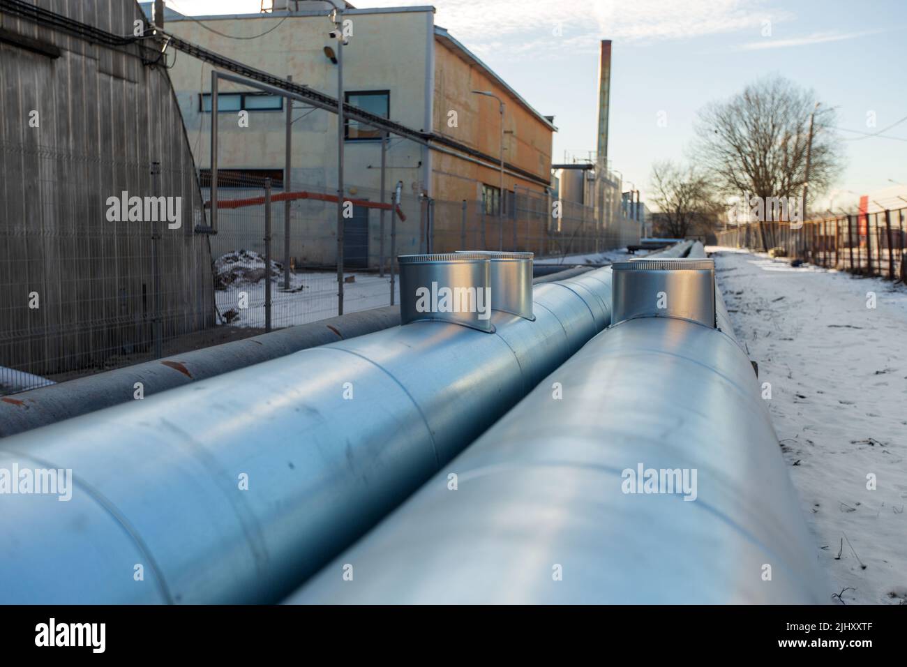 outdoor pipeline and old hangar in winter Stock Photo - Alamy