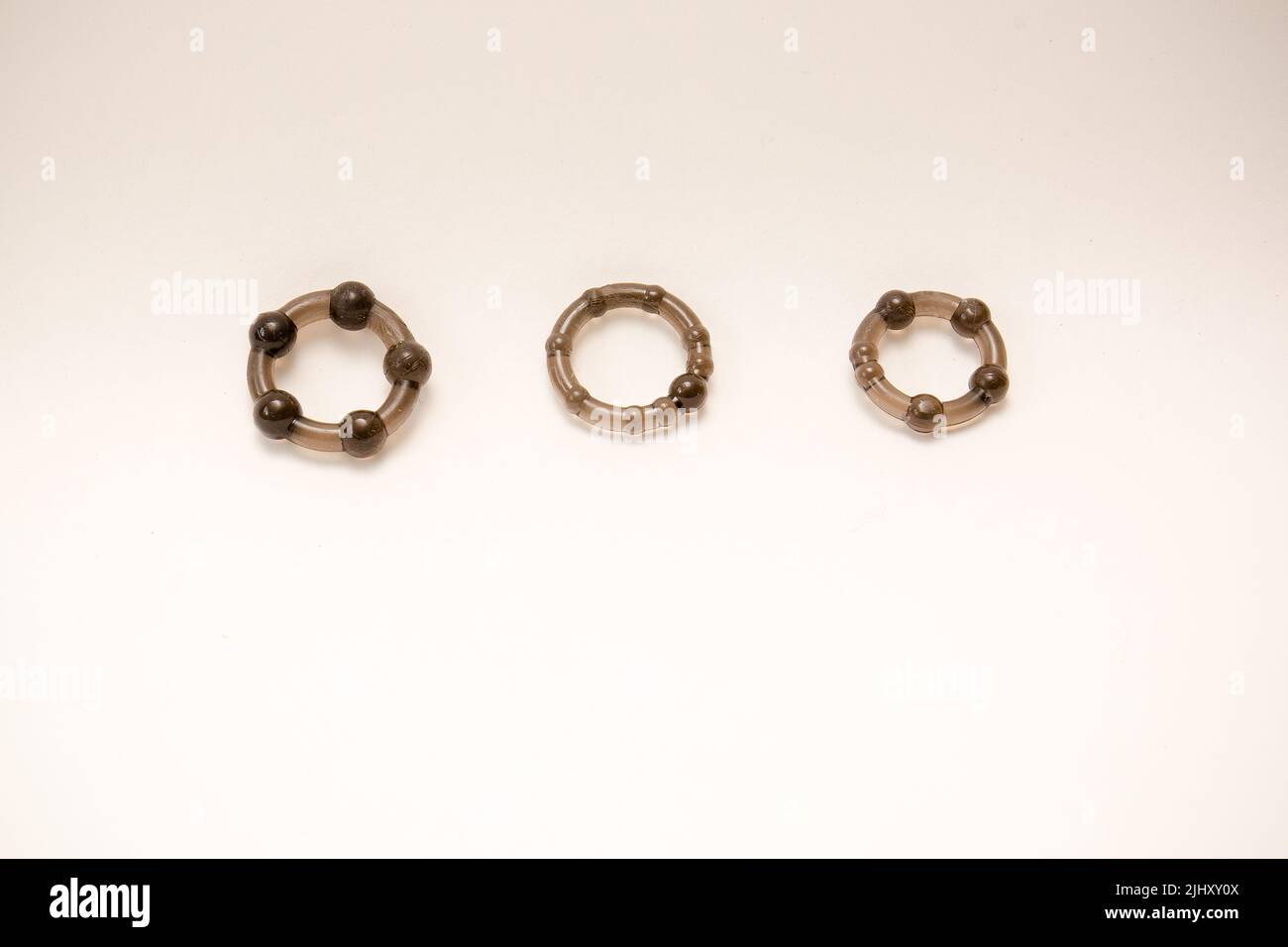 Three silicon ribbed rings in small, medium and large isolated on white ...